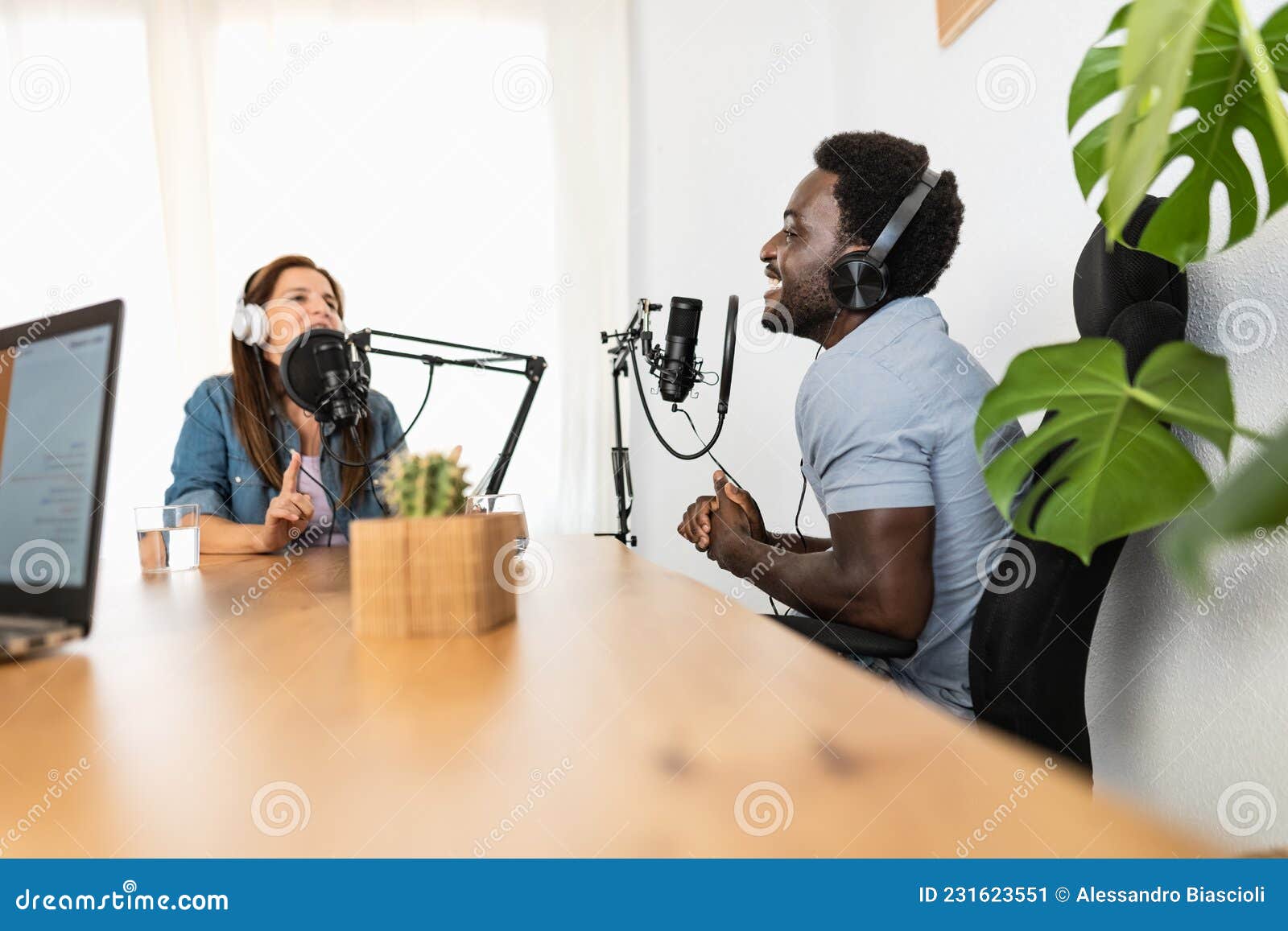 Multiracial People Recording a Podcast Using Microphone and Laptop from ...