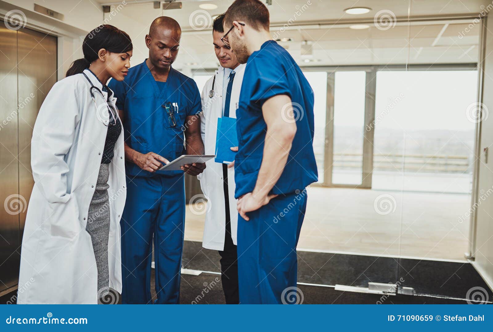 Multiracial Team of Doctors Discussing a Patient Stock Image - Image of ...