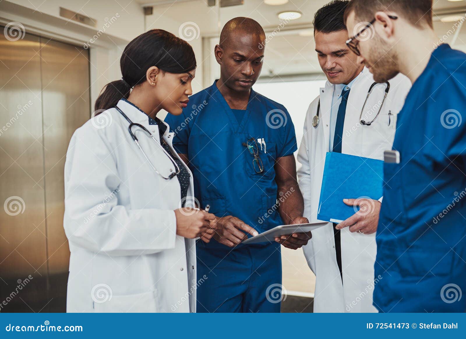 Multiracial Team of Doctors Discussing a Patient Stock Image - Image of ...