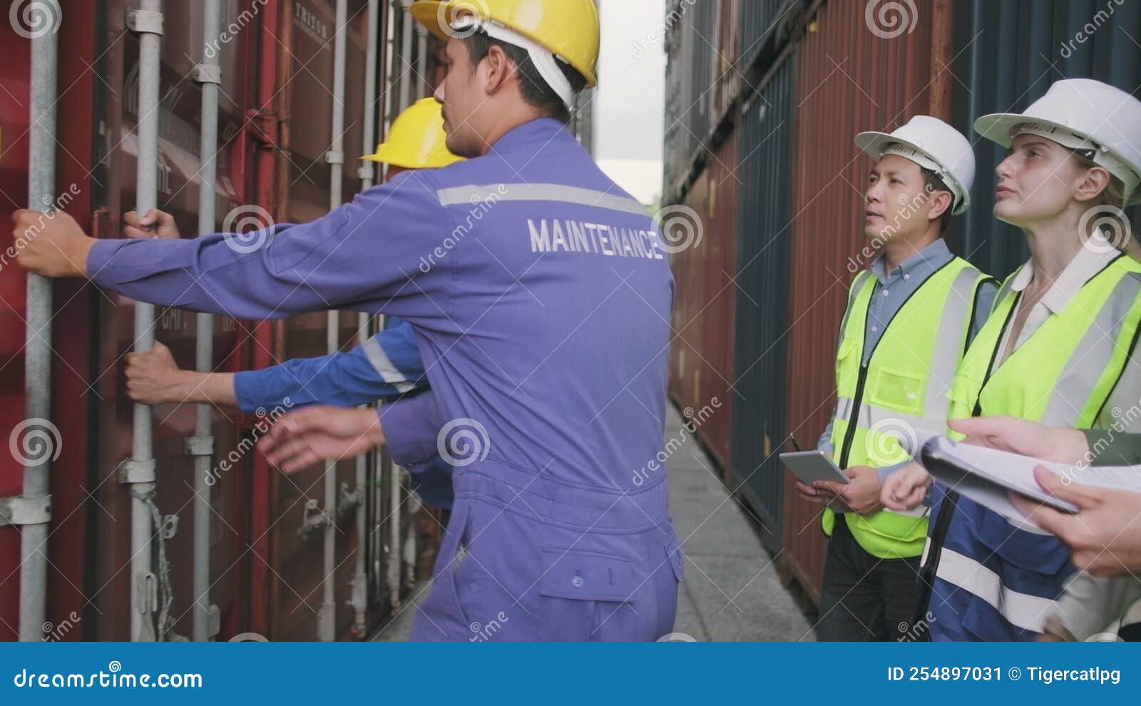 The Multiracial Workers Inspect Shipping Cargo at Nook of the Container ...