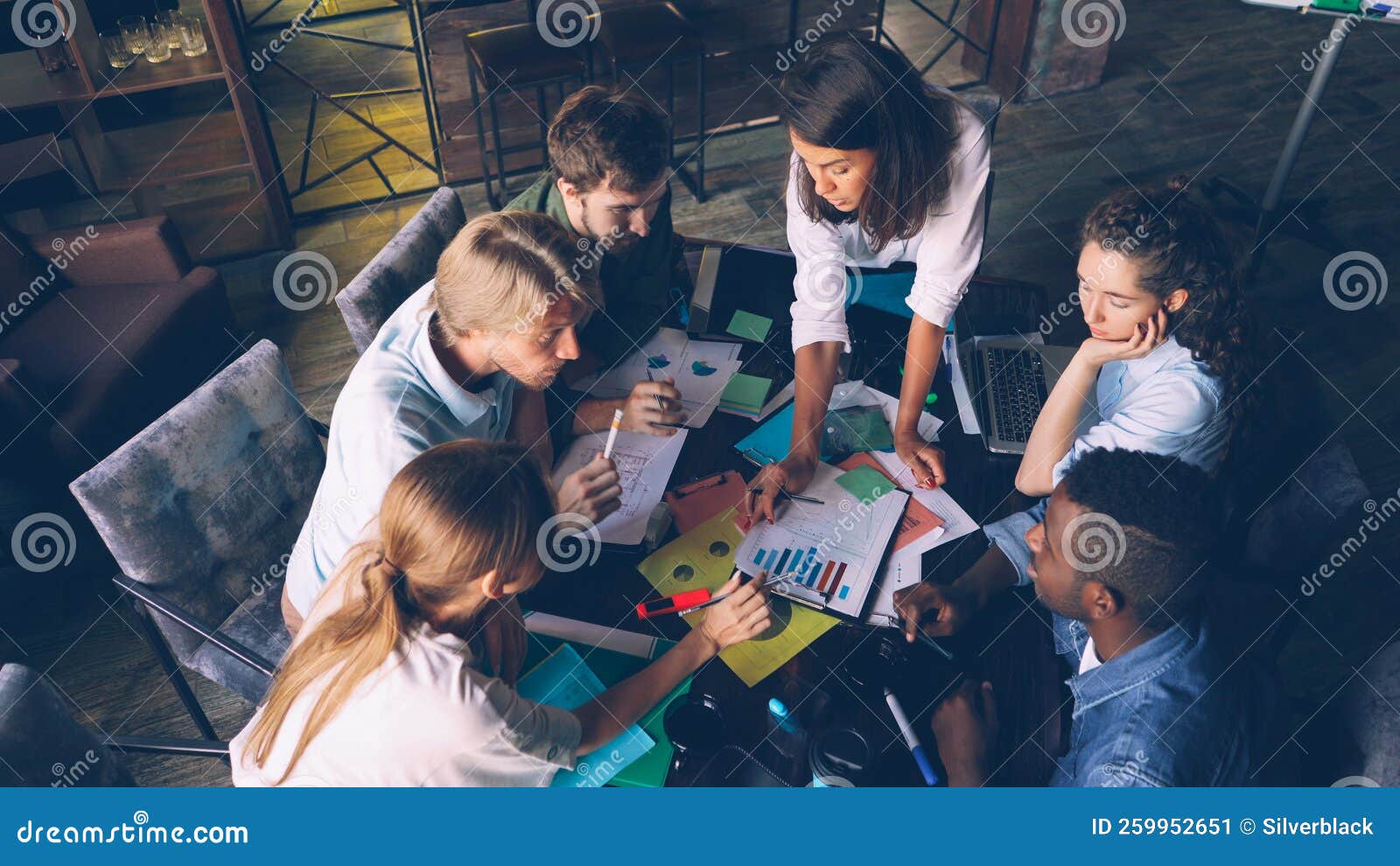 Multiracial Workgroup is Analyzing Diagram and Writing on Stickers ...