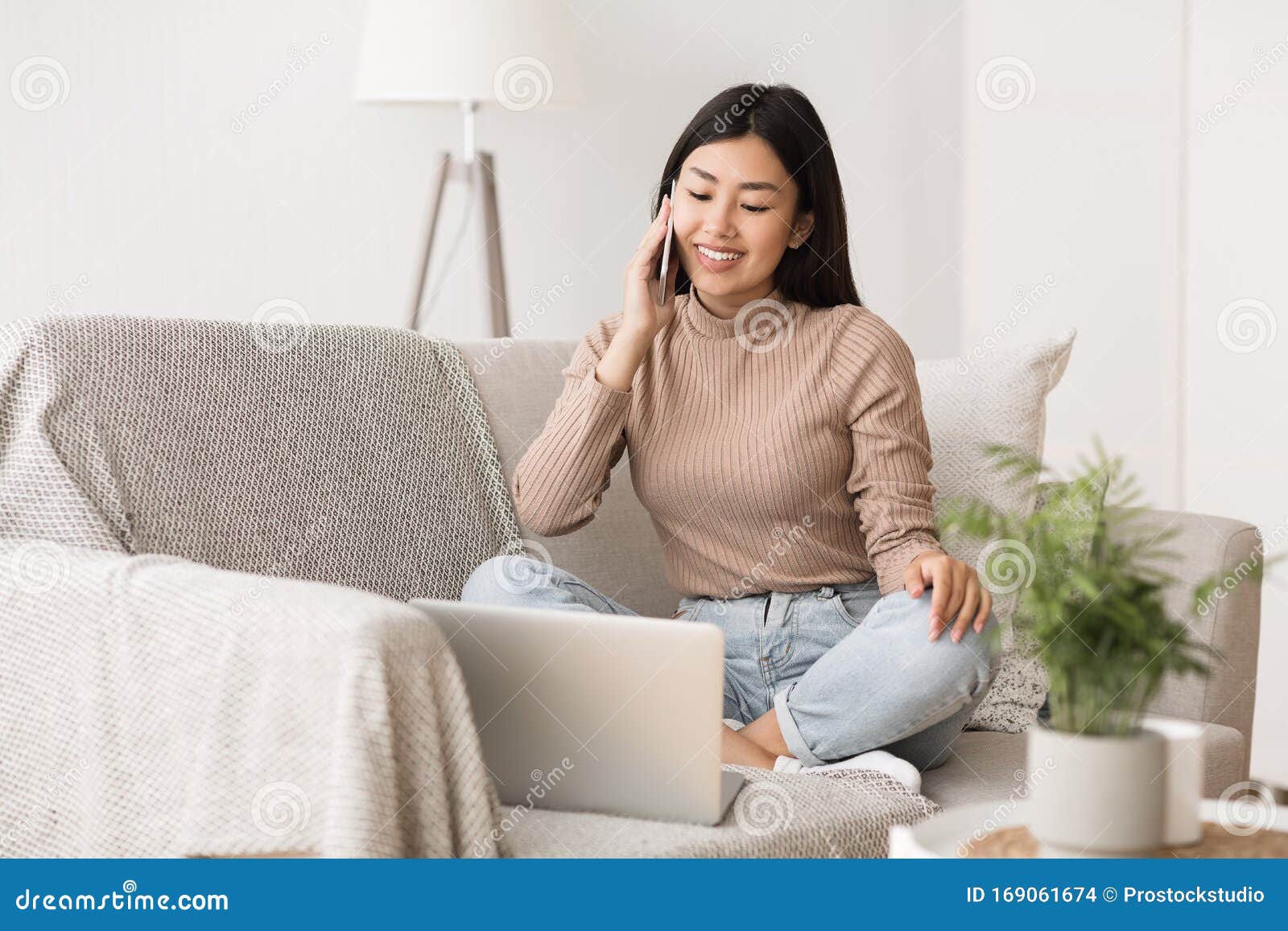 Multitasking Concept. Girl Using Laptop and Talking on Cellphone Stock ...