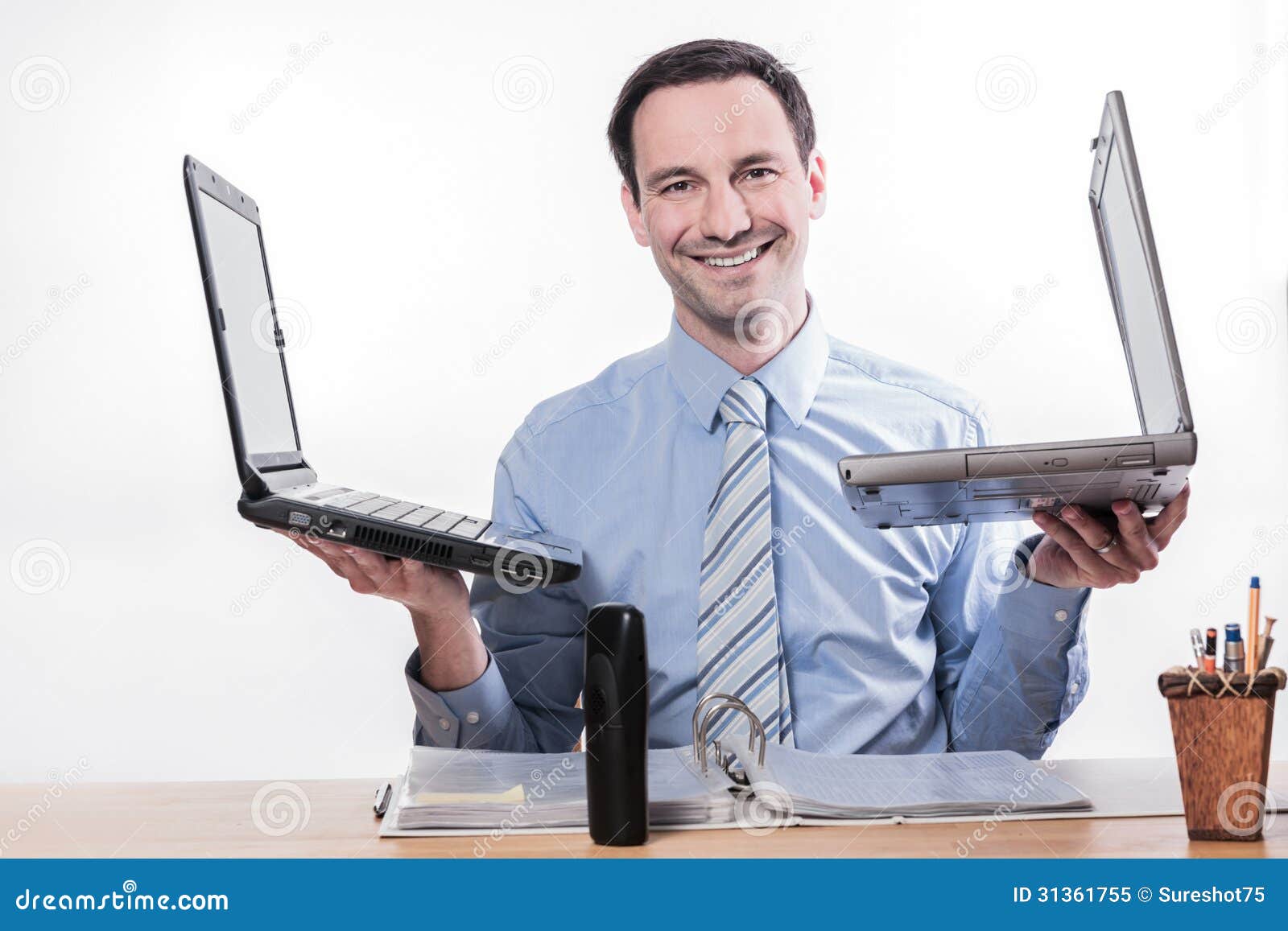Multitasking Employee with 2 Laptops Smiling Stock Image - Image of ...