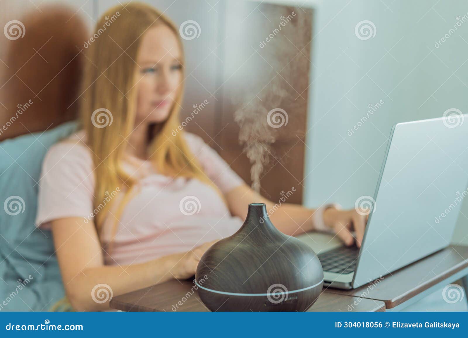 Multitasking Expectant Woman Enhances Her Home Workspace, Using an ...