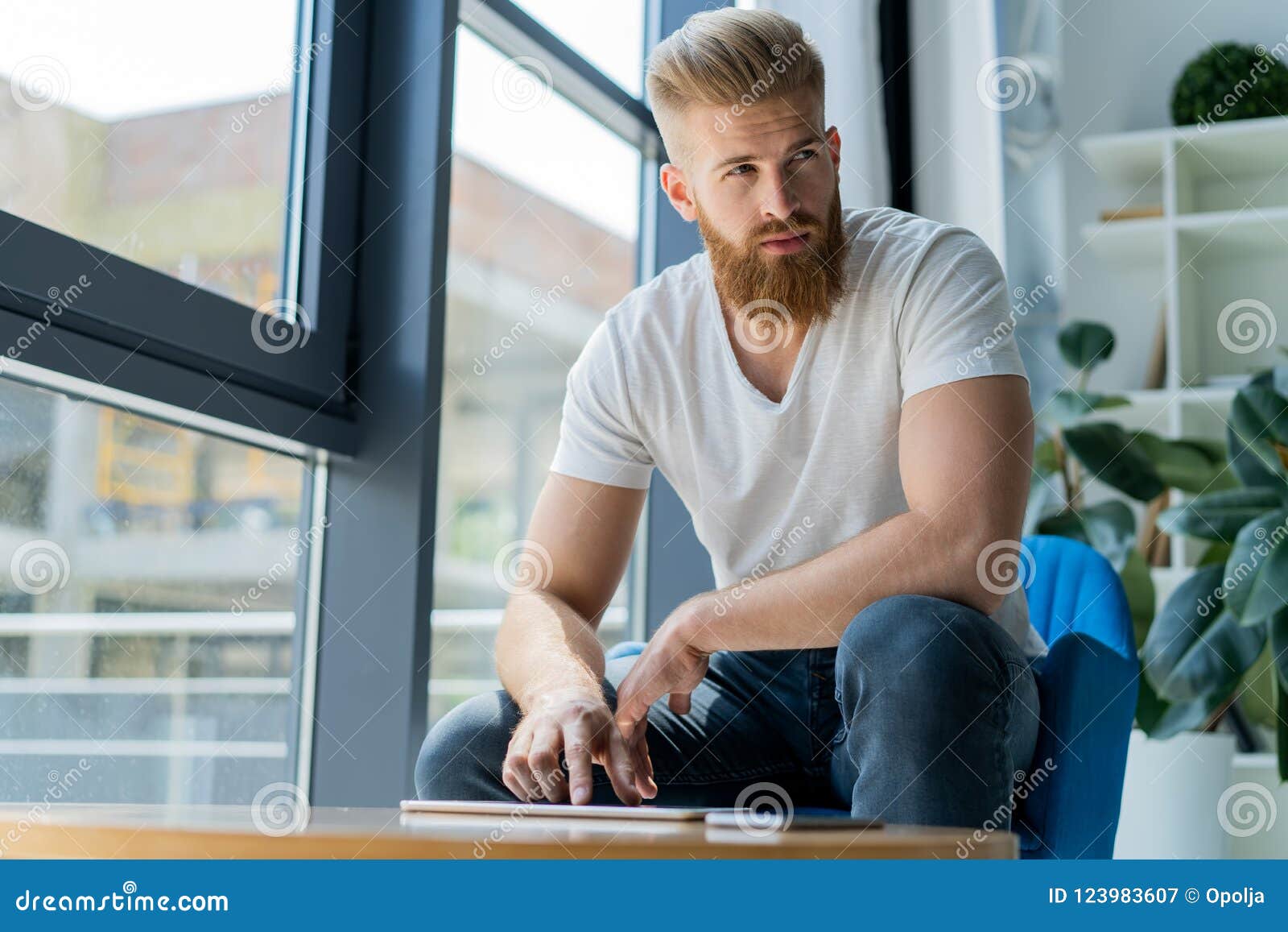 Multitasking. Handsome Young Man Wearing Glasses and Working with ... Multitasking. Handsome Young Man Wearing Glasses and Working with ...