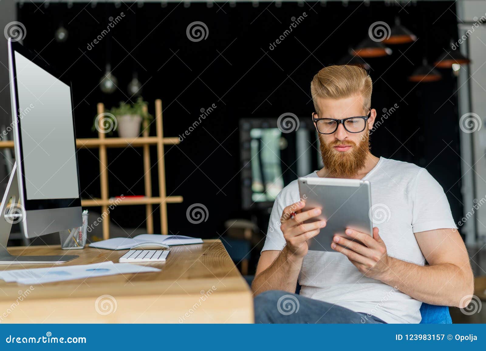 Multitasking. Handsome Young Man Wearing Glasses and Working with ...