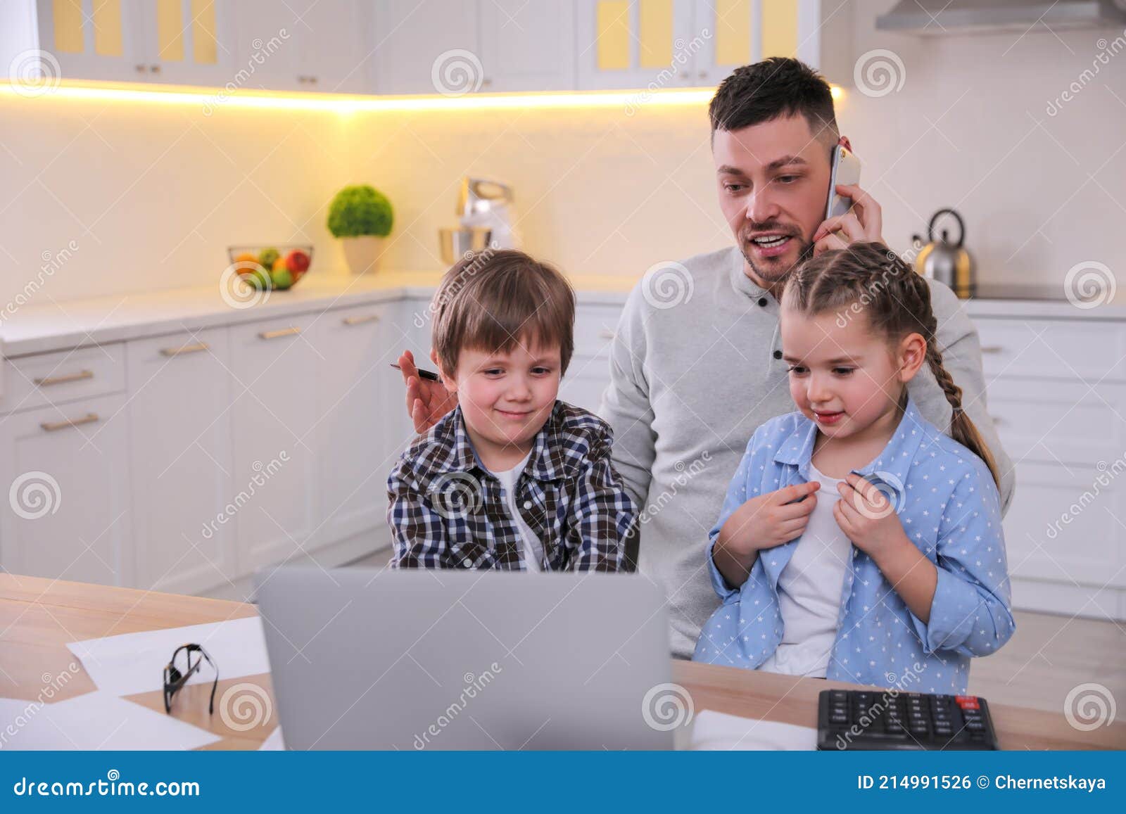 Multitasking Man Combining Parenting and Work at Home Stock Photo ...