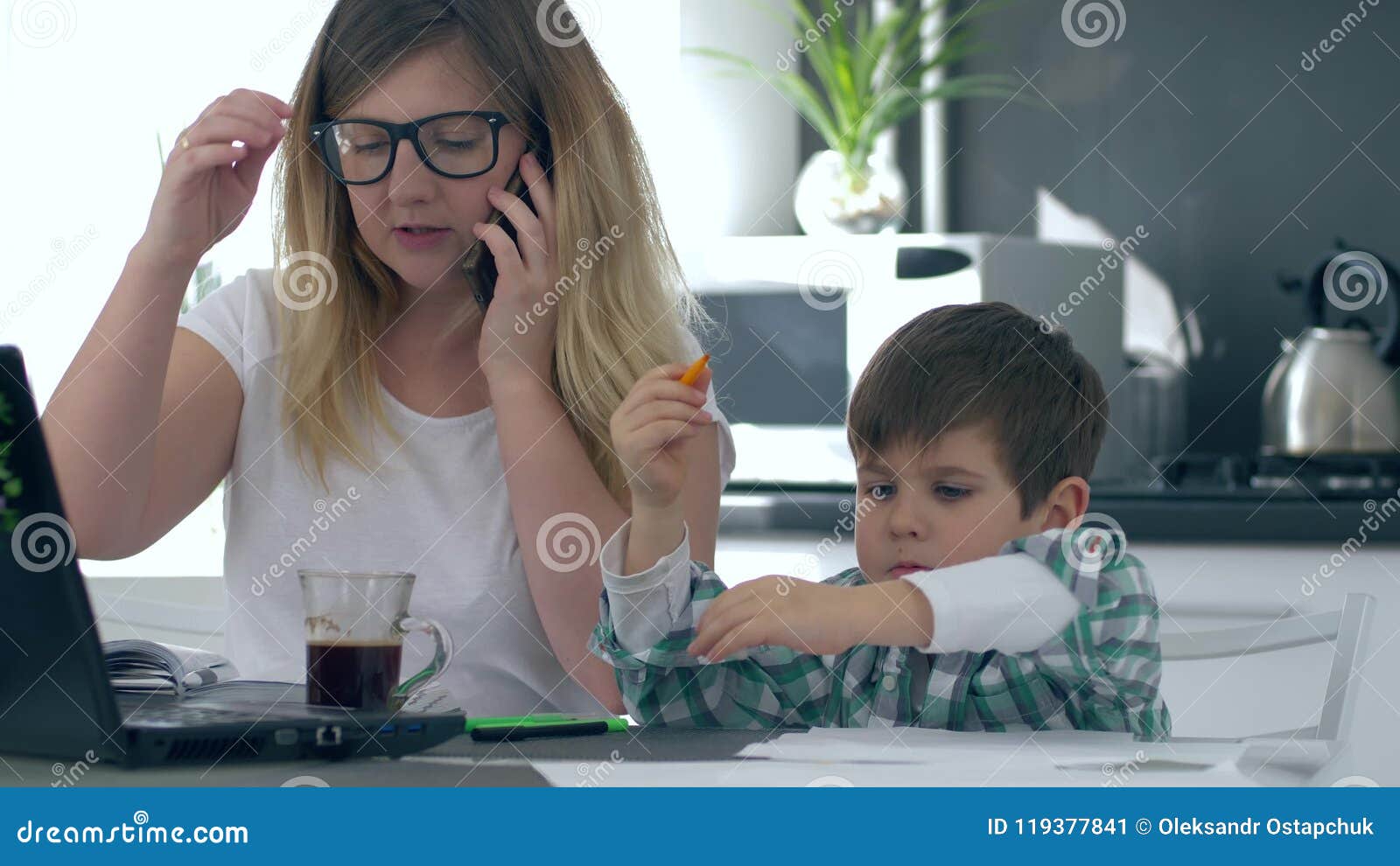 Multitasking Mom Work at Home with Child and Talking on Telephone Stock ...
