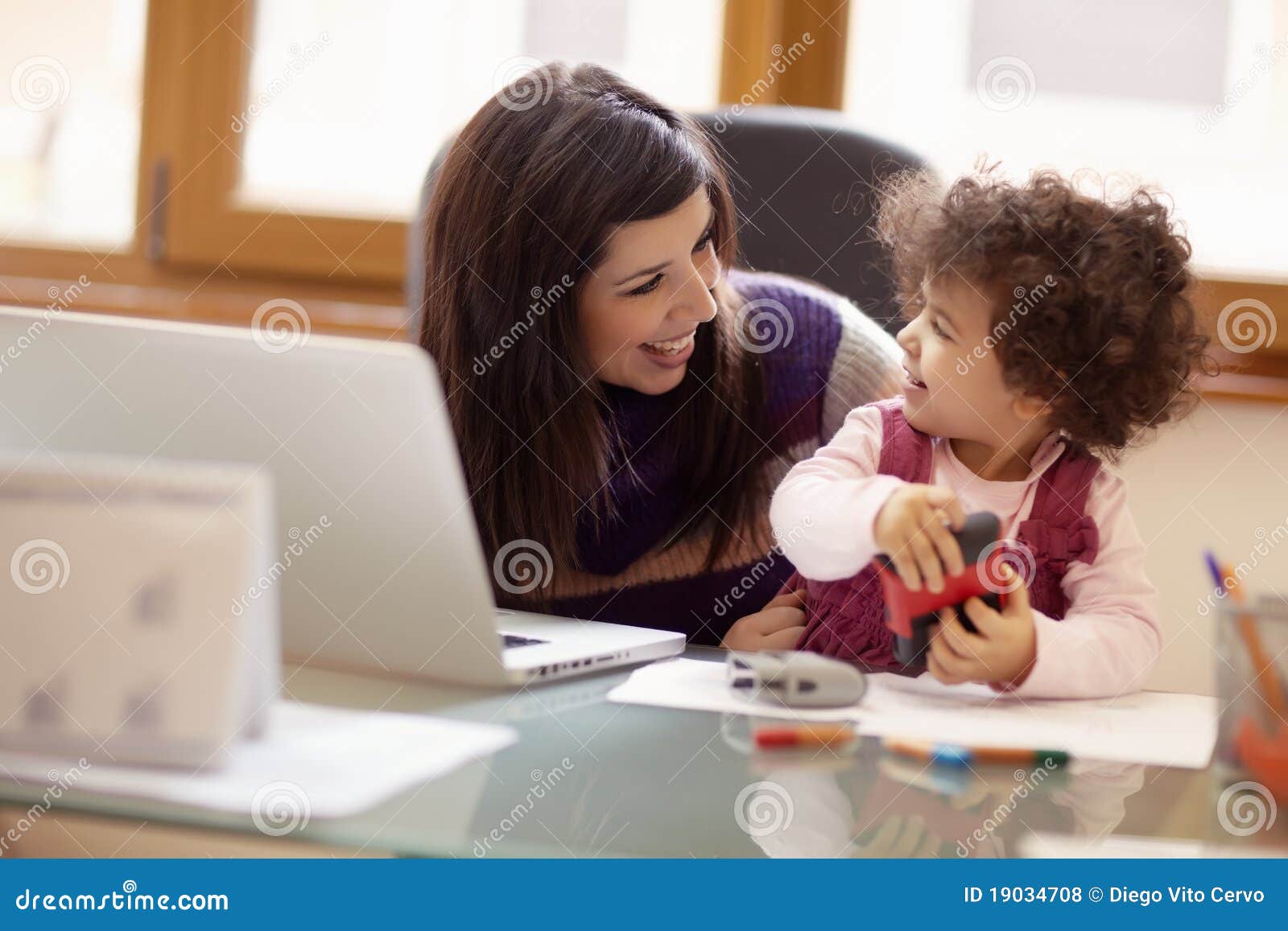 Multitasking Mother with Her Daughter Stock Photo - Image of house ...