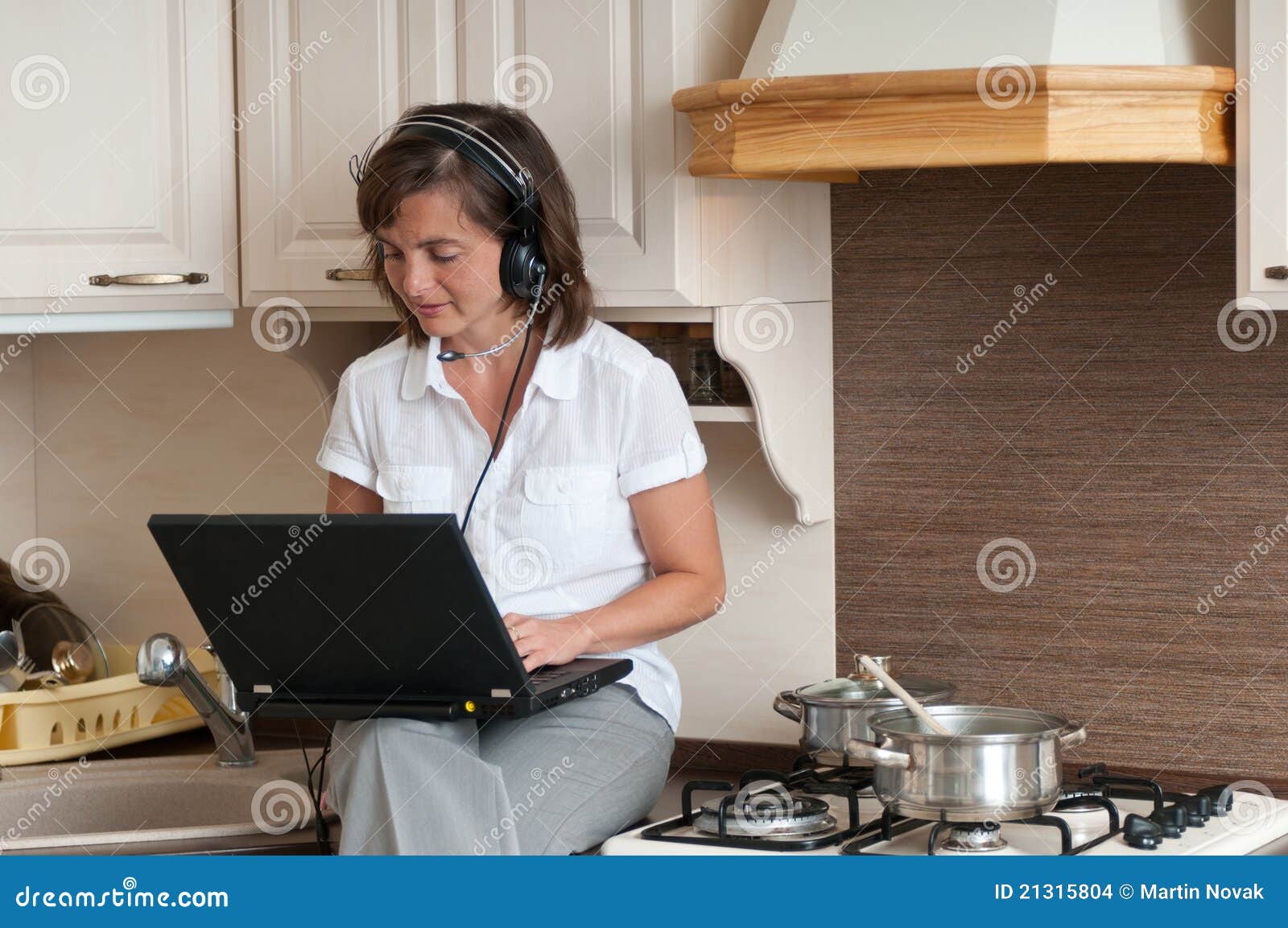 Multitasking - Preparing Meal and Working Stock Photo - Image of ...