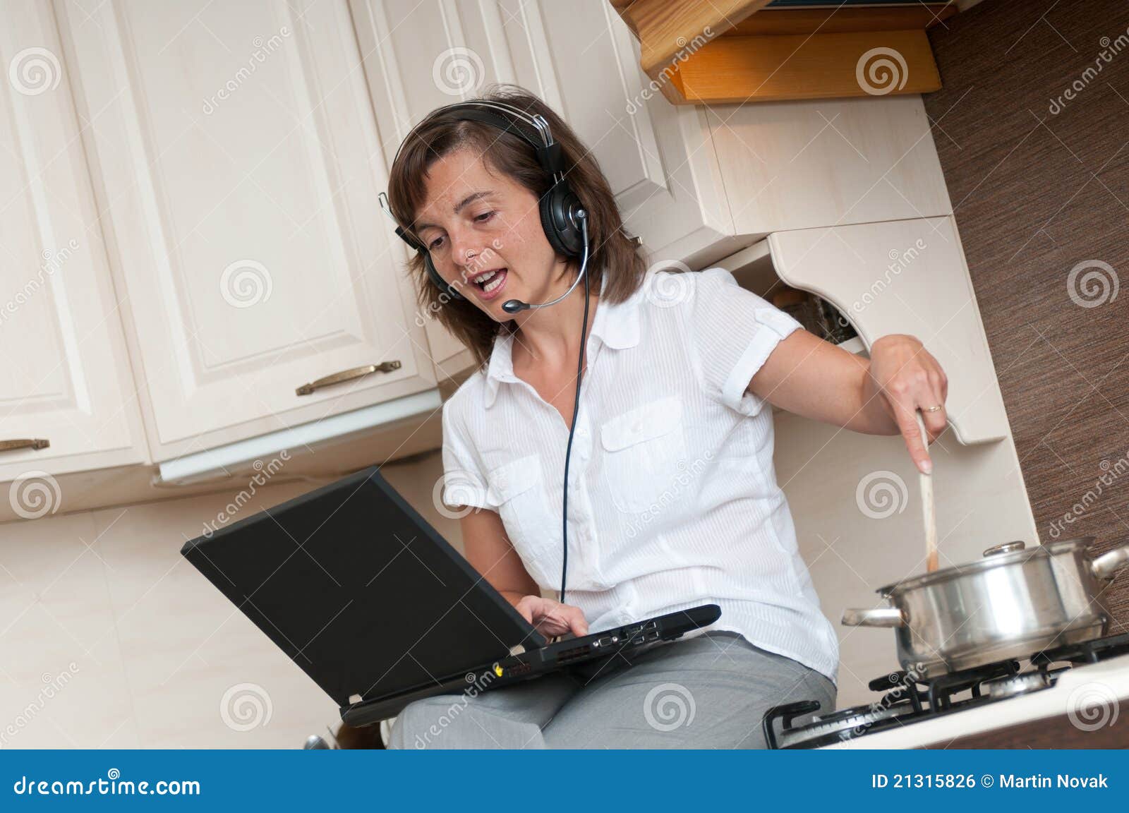Multitasking - Preparing Meal and Working Stock Photo - Image of ...