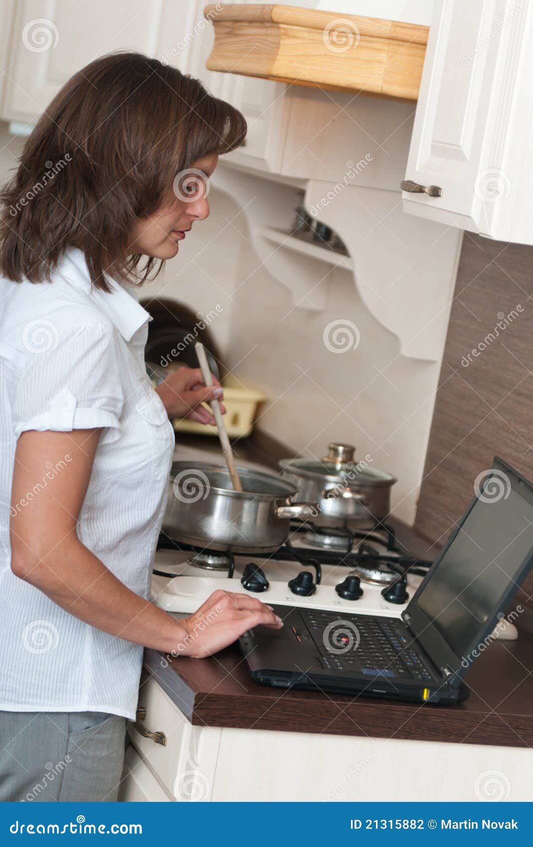 Multitasking - Preparing Meal and Working Stock Photo - Image of ...