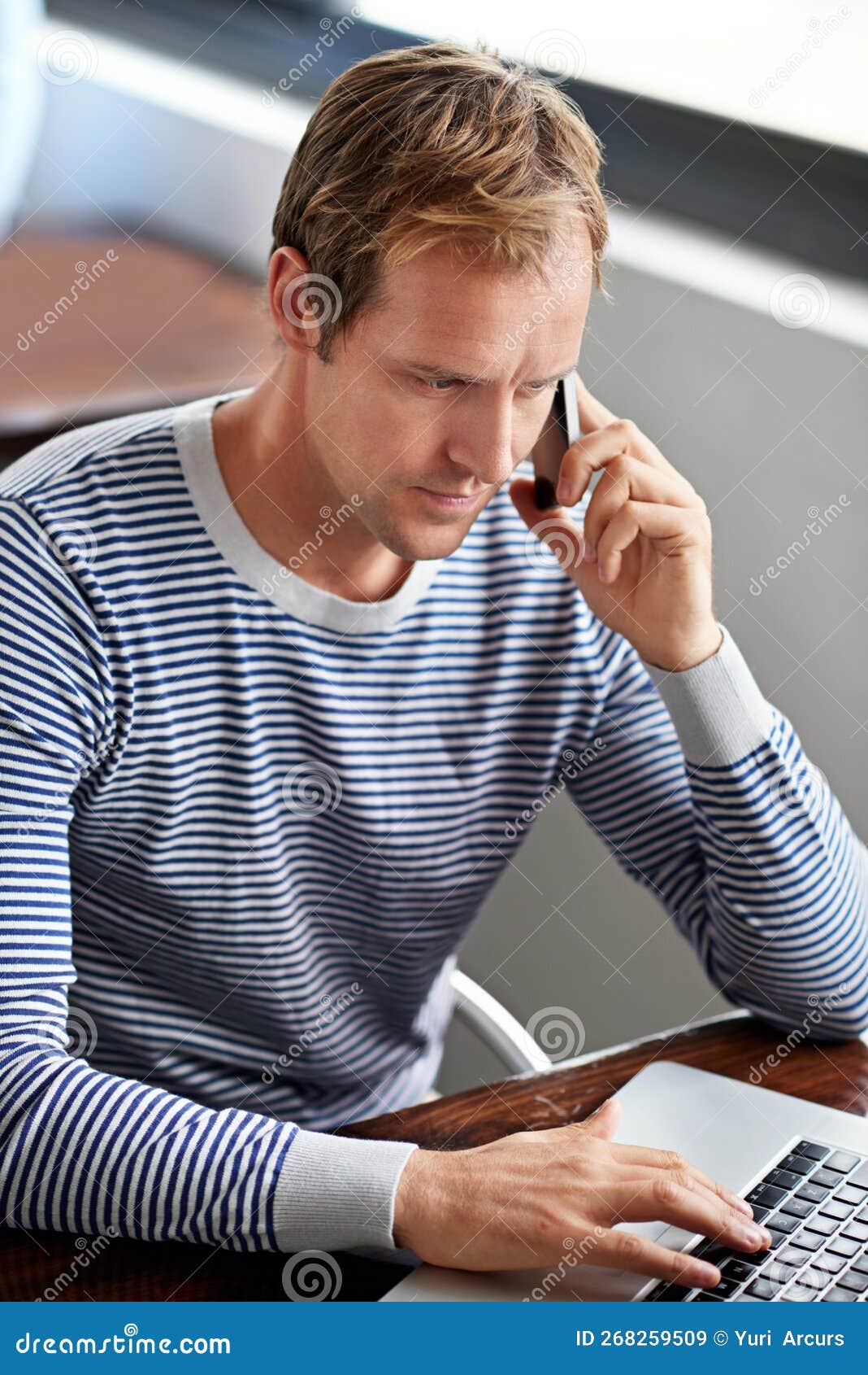 Multitasking with Technology. a Man Talking on His Cellphone in a ...