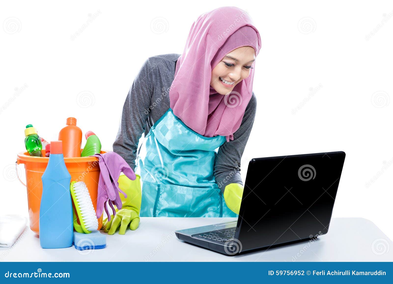 Multitasking Young Housewife Using Laptop while Cleaning Table Stock ...