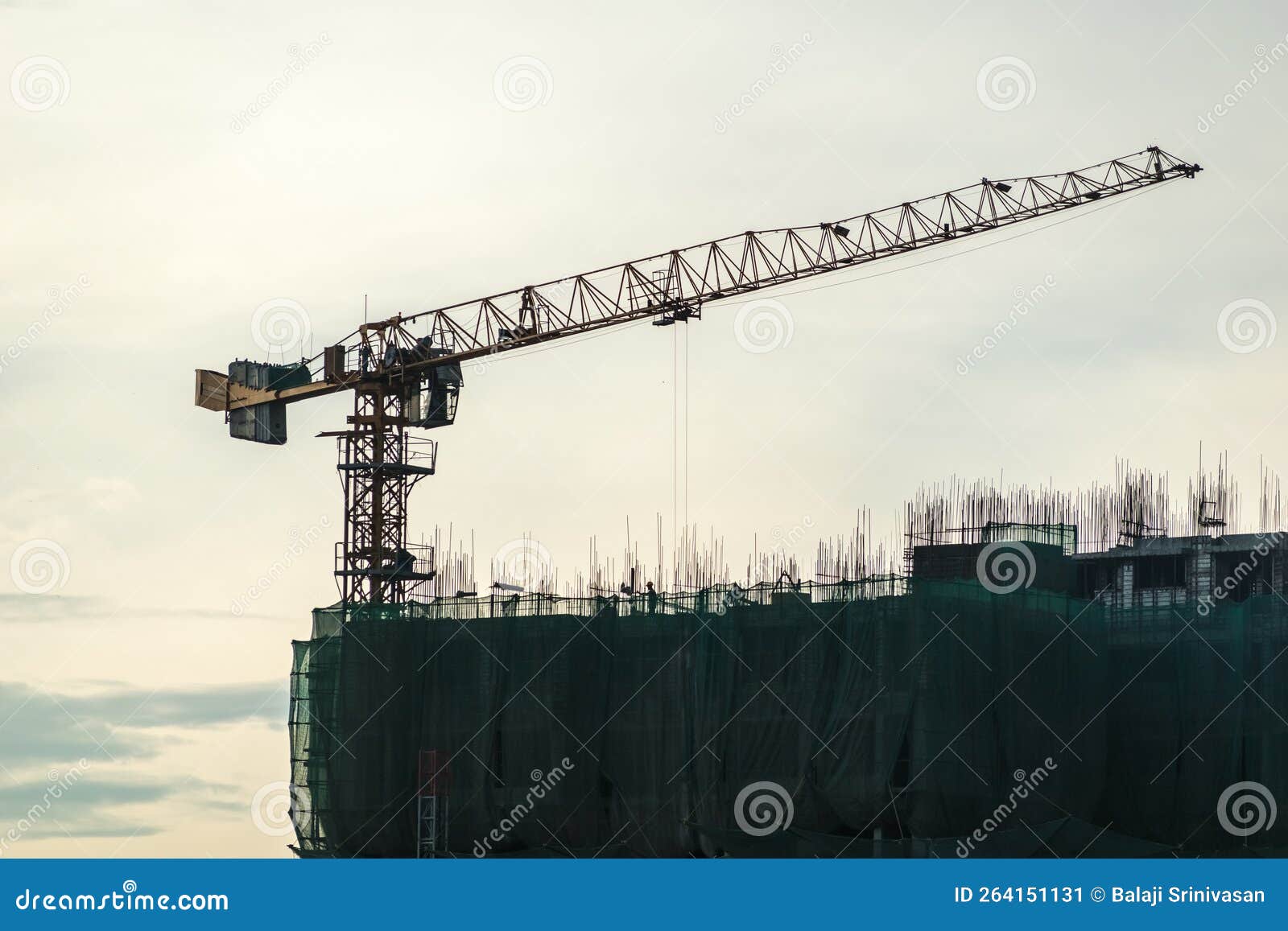 Construction Crane on Top of a High Rise Skyscraper Under Construction ...