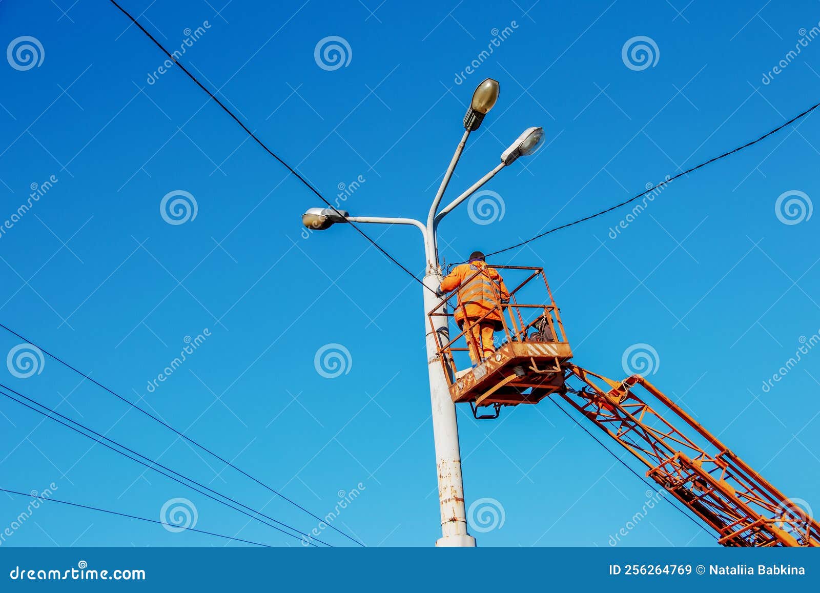 A Municipal Worker in Protective Equipment Performs Hazardous Work To ...