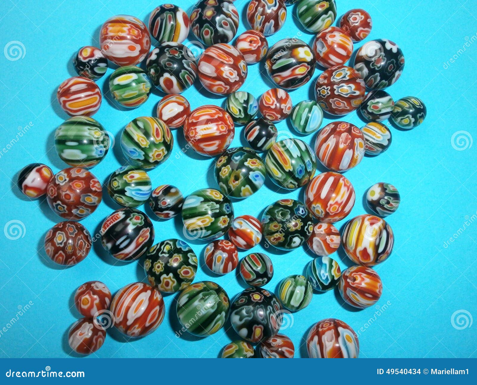 Murrine on a turquoise stock photo. Image of marbles - 49540434