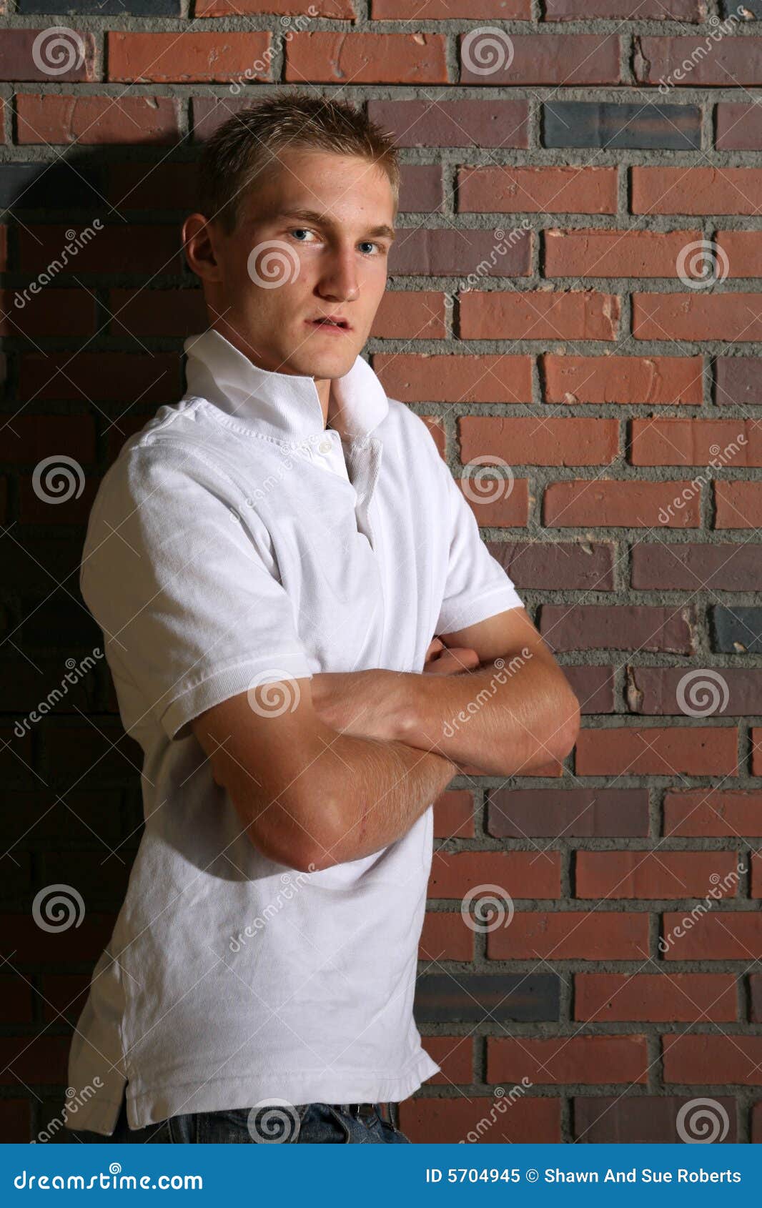 Muscle man and brick wall stock image. Image of stand - 5704945