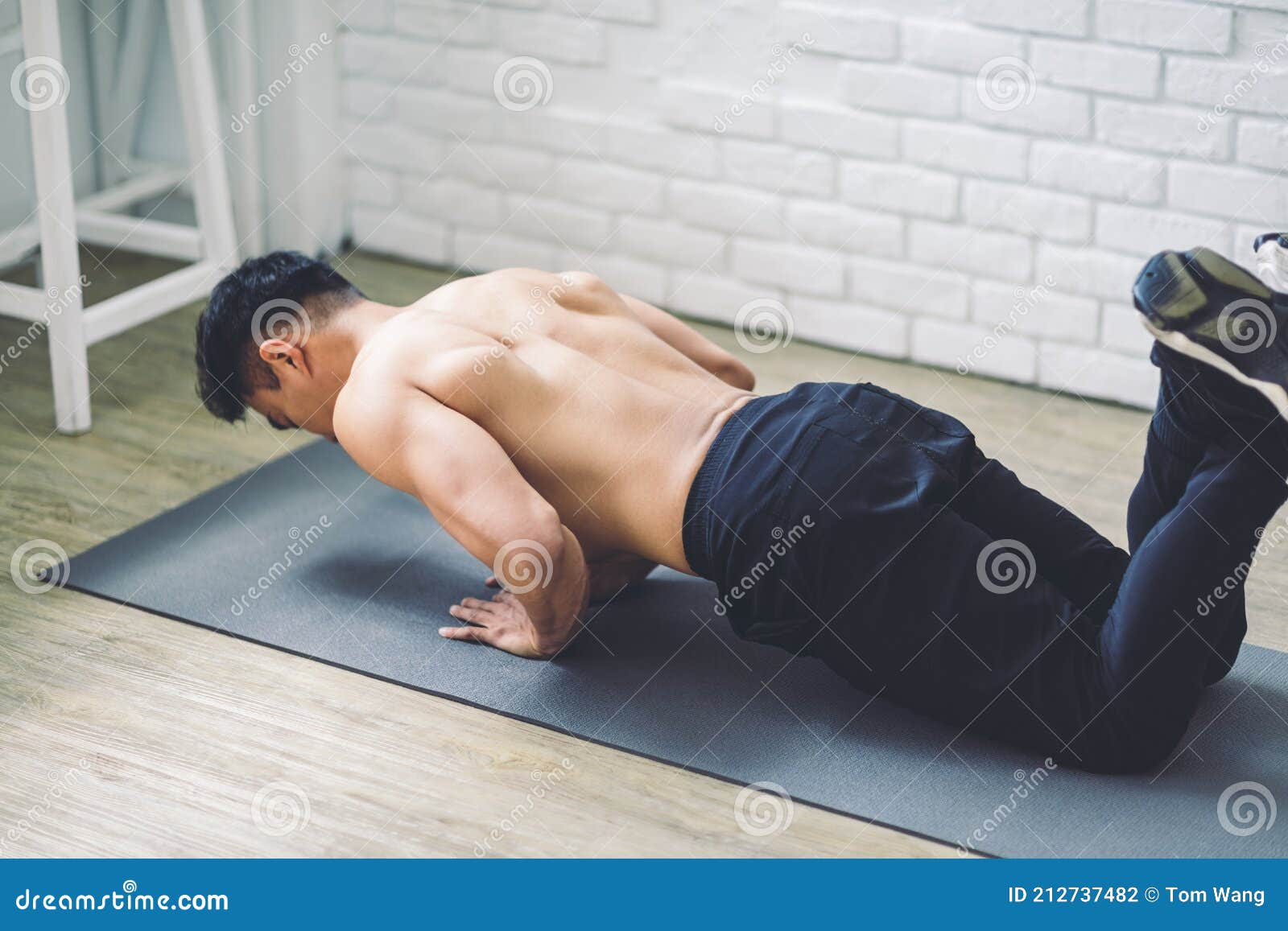 Muscular Asian Young Man Doing Exercises on Floor at Home Stock Photo ...