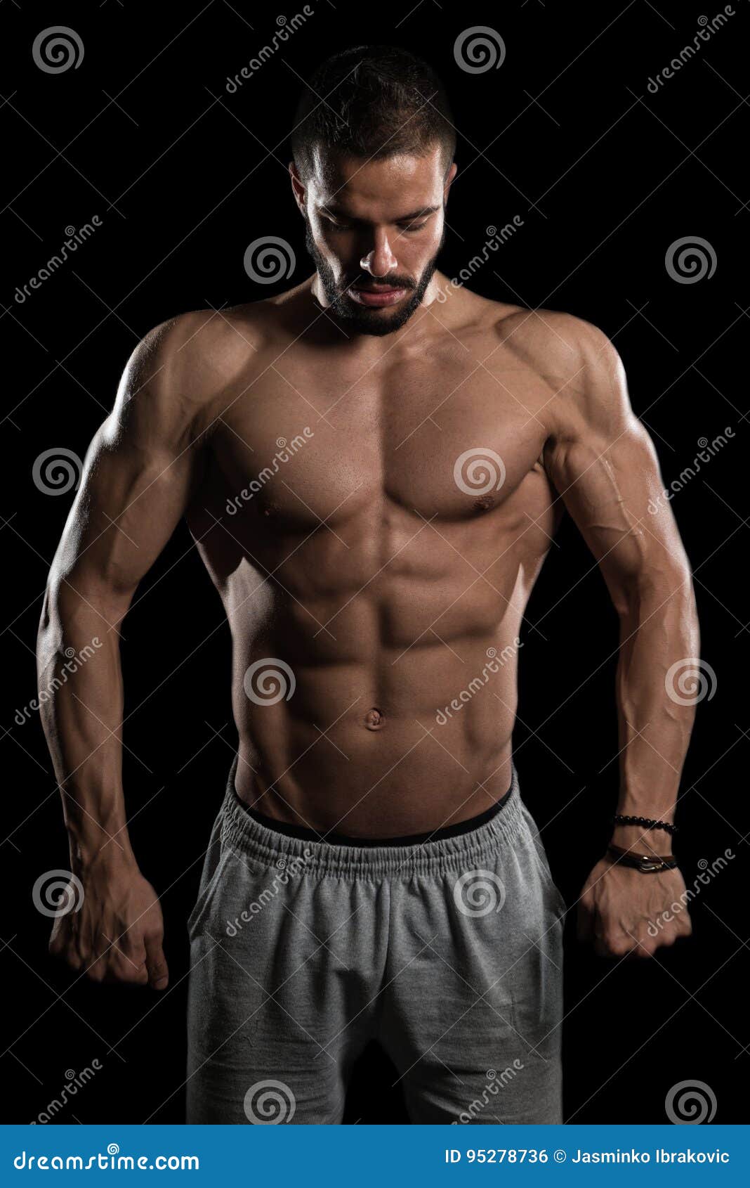 Muscular Athlete Flexing Muscles on Black Background Stock Photo ...