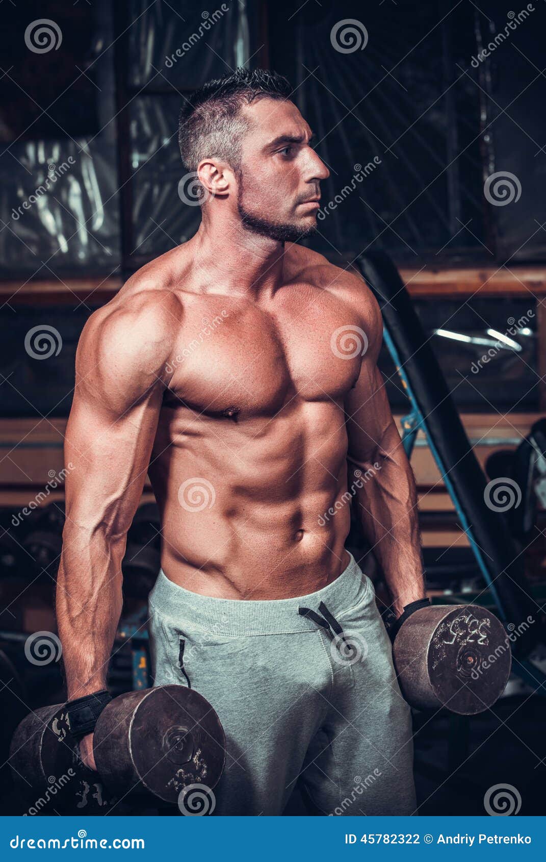 Muscular Bodybuilder Doing Exercises with Dumbbells Stock Photo - Image ...