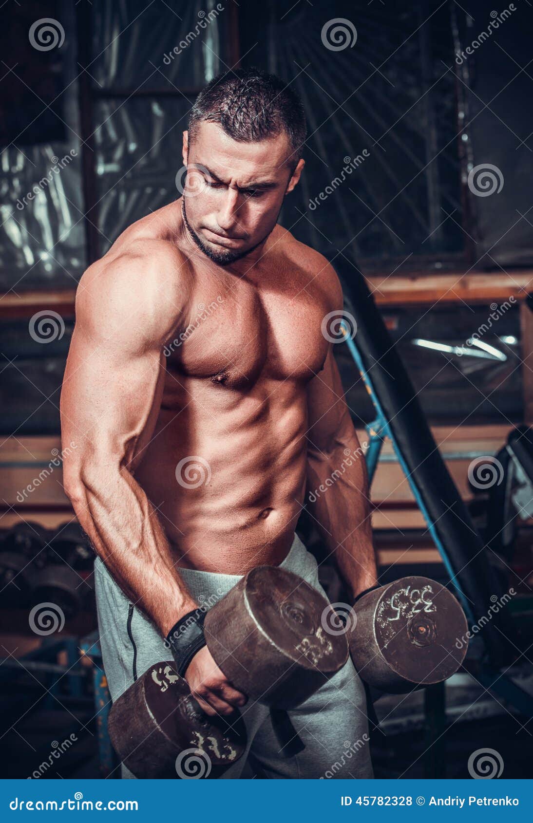 Muscular Bodybuilder Doing Exercises with Dumbbells Stock Photo - Image ...