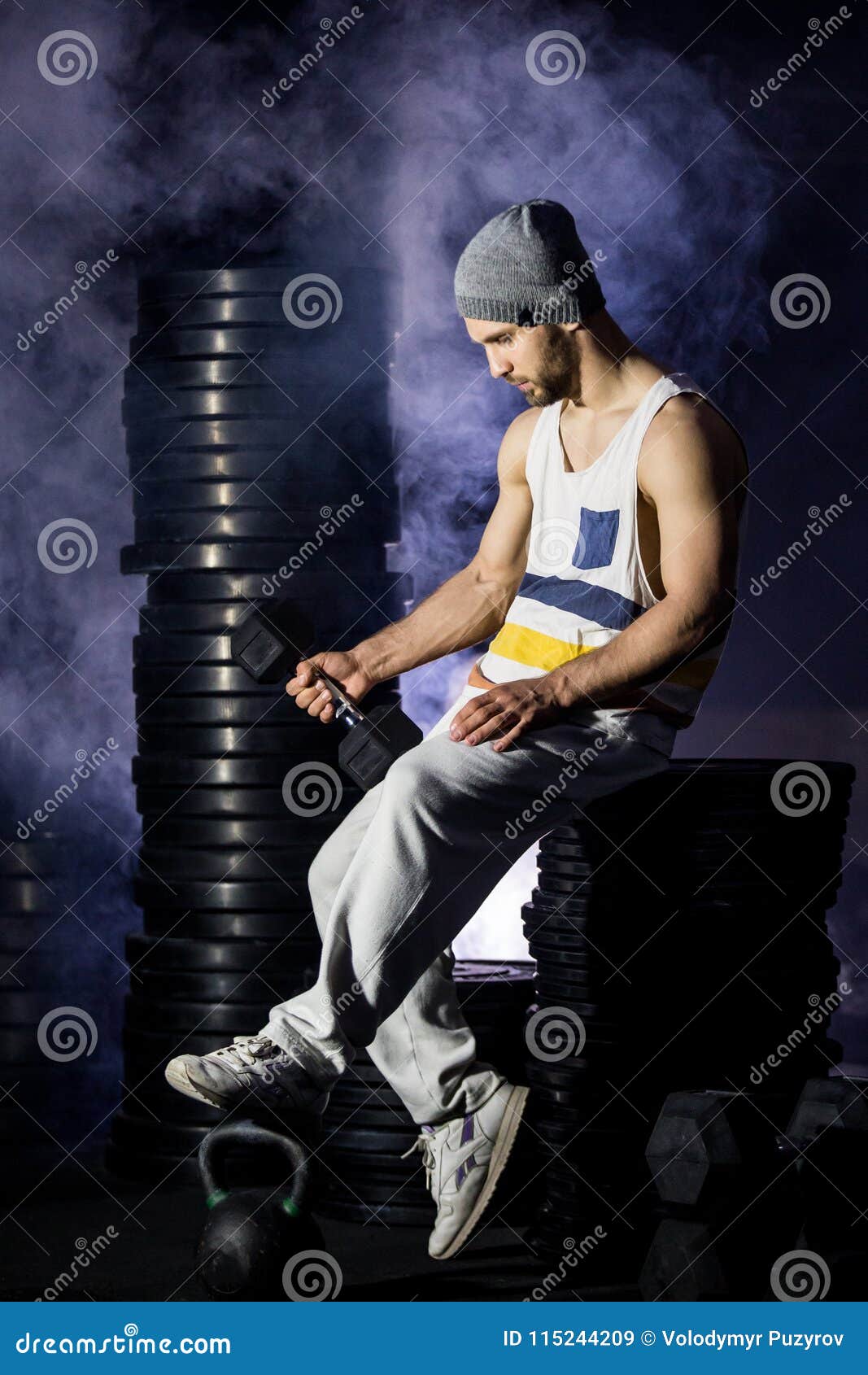 Muscular Bodybuilder with Dumbbells in Smoke Stock Image - Image of ...