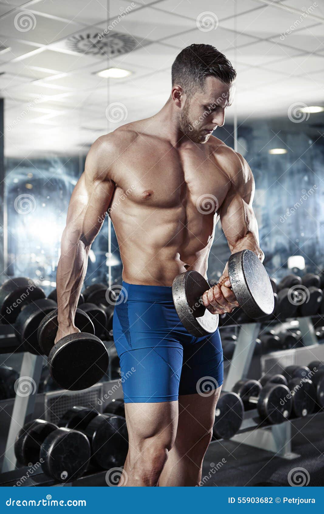 Muscular Bodybuilder Guy Doing Exercises with Dumbbell Stock Photo ...