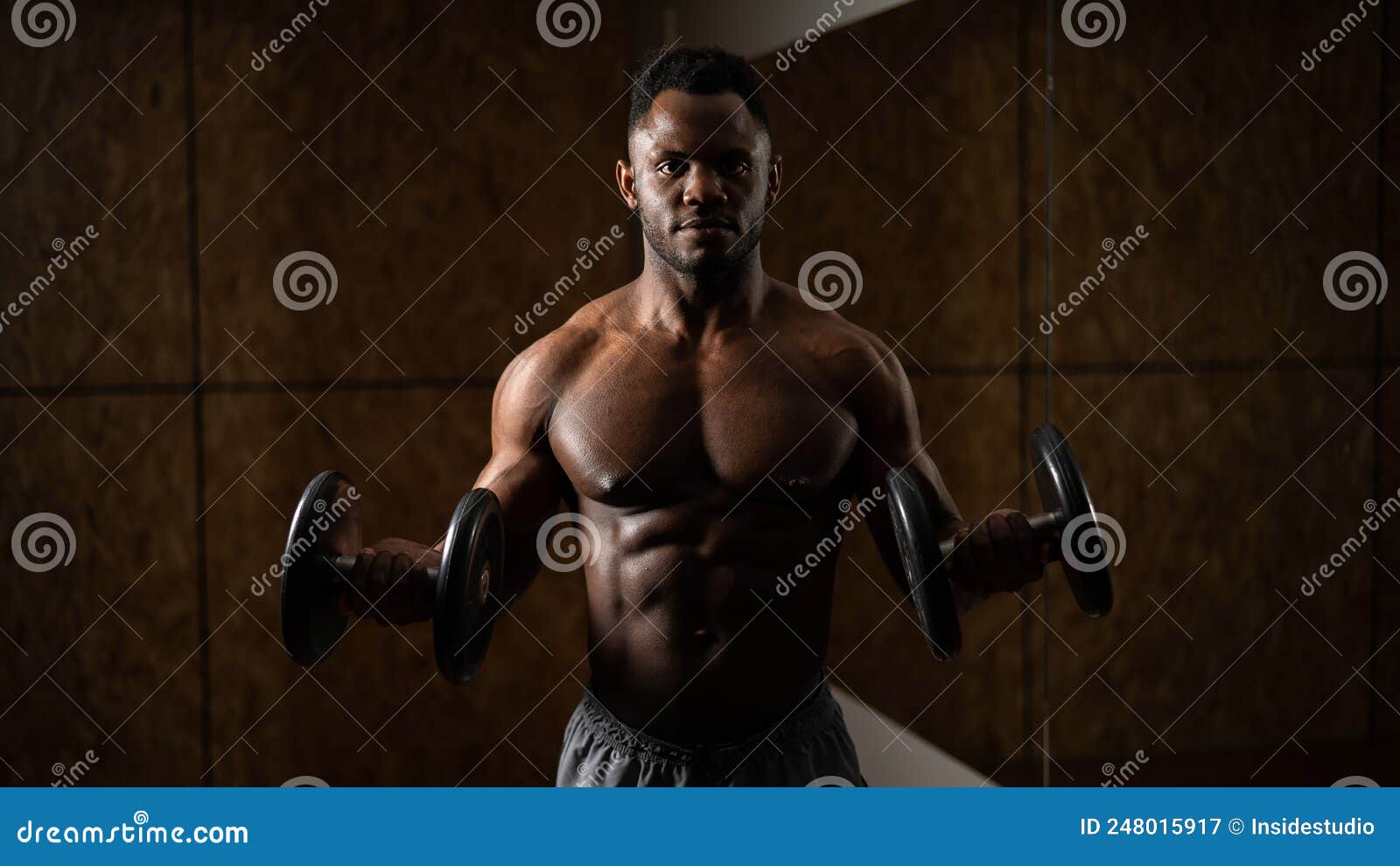 Muscular Dark-skinned Man Doing an Exercise with Dumbbells. Stock Image ...