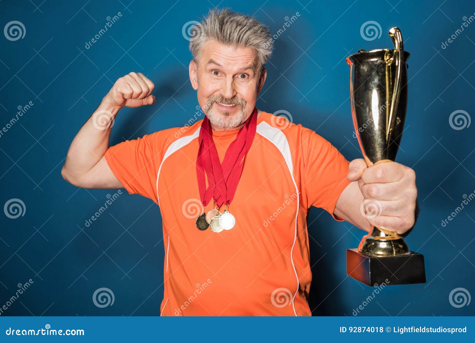 Muscular Elderly Man Holding Trophy and Showing Biceps Stock Photo ...