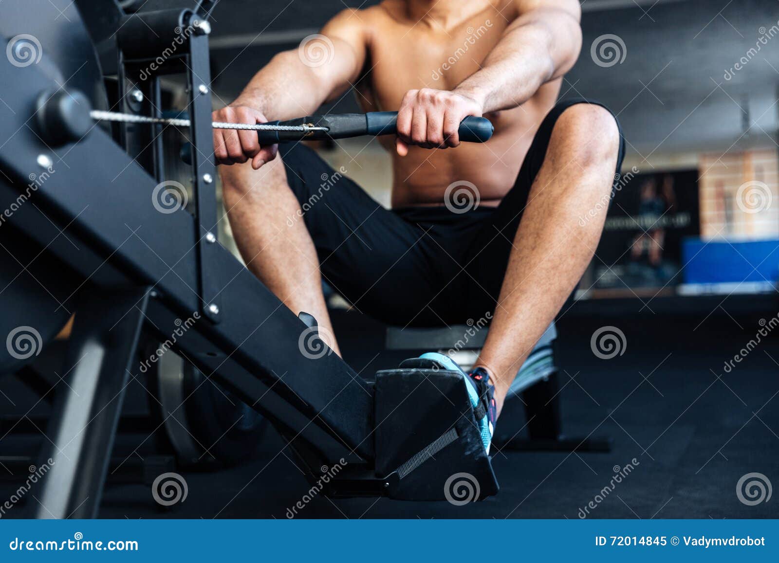 Muscular Fitness Man Using Rowing Machine Stock Image - Image of ...