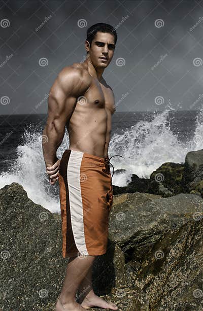 Muscular guy by the ocean stock photo. Image of portrait - 6617872