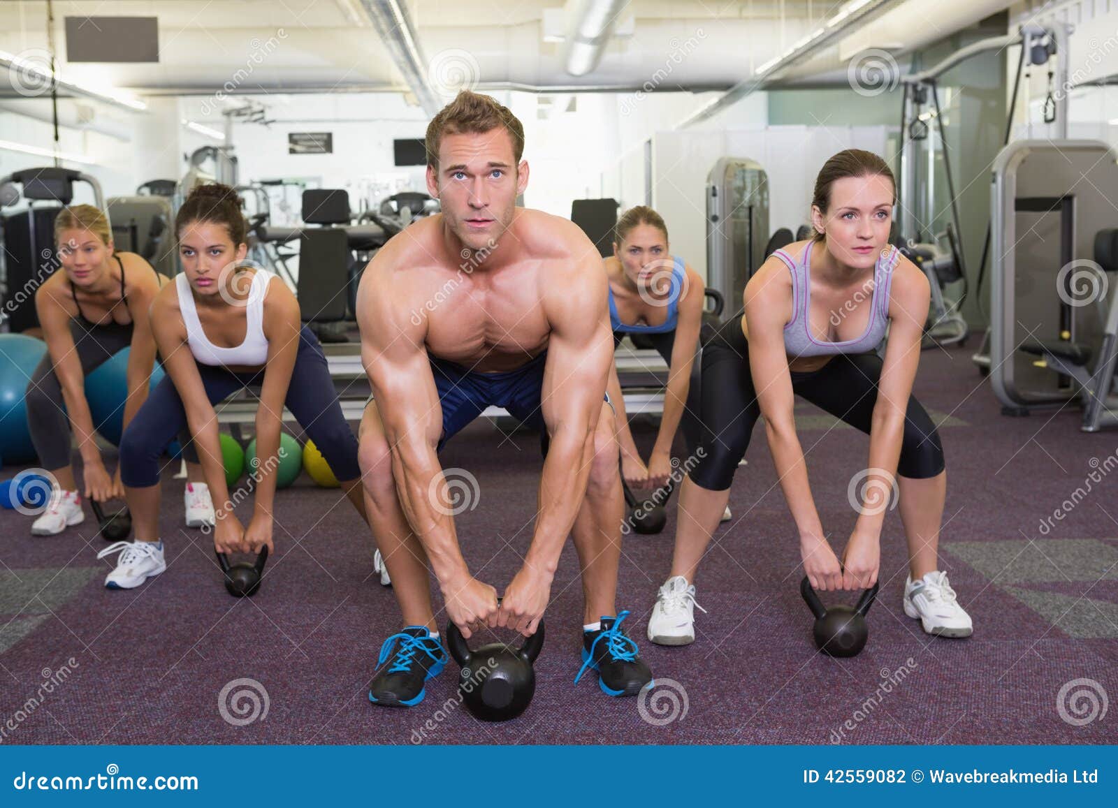 Muscular Instructor Leading Kettlebell Class Stock Photo - Image of ...