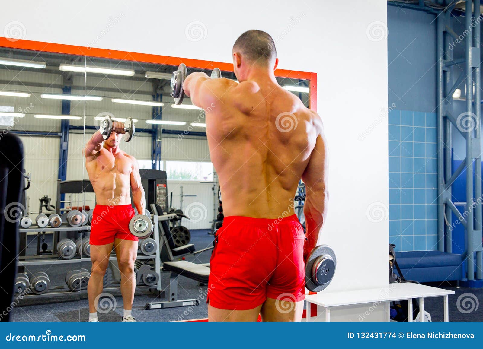 Male Bodybuilder Doing Exercises in a Gym Stock Photo - Image of ...