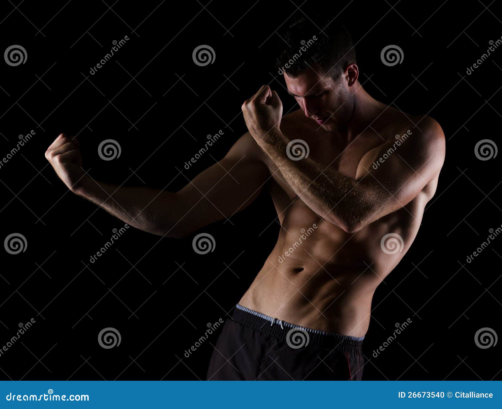 Muscular Man in Attack Pose on Black Stock Photo - Image of pose ...