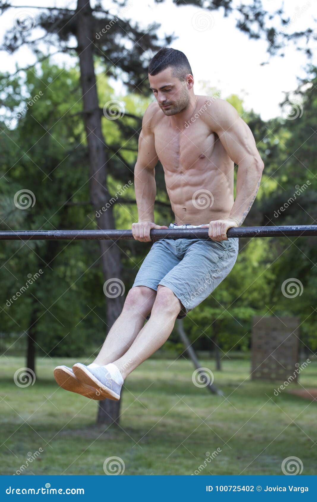 Young Fit Man Doing Exercises on the Horizontal Bar Stock Photo - Image ...