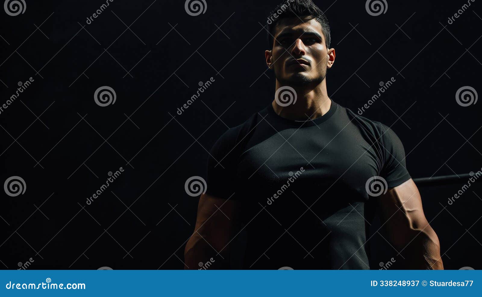 Muscular Man in Black Shirt in Dramatic Low Light Setting Stock Image ...
