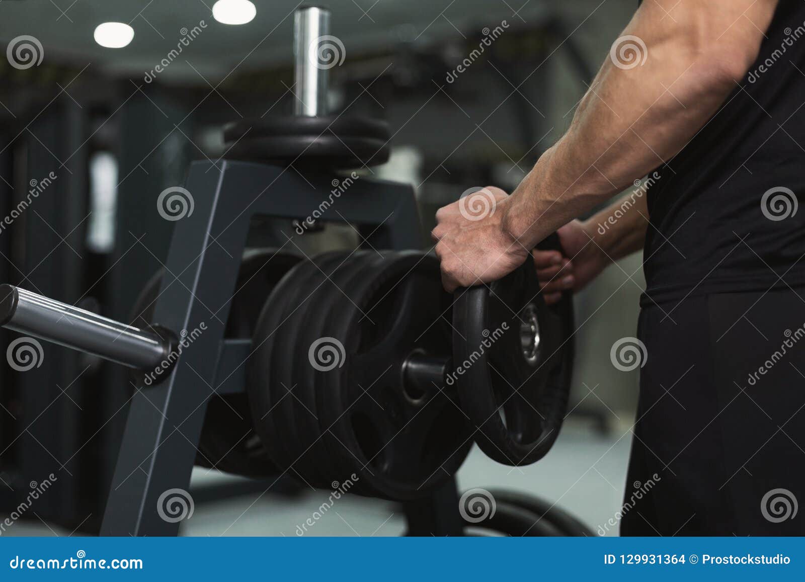Muscular Man Bodybuilder Picking Up Heavy Dumbbell Stock Photo - Image ...
