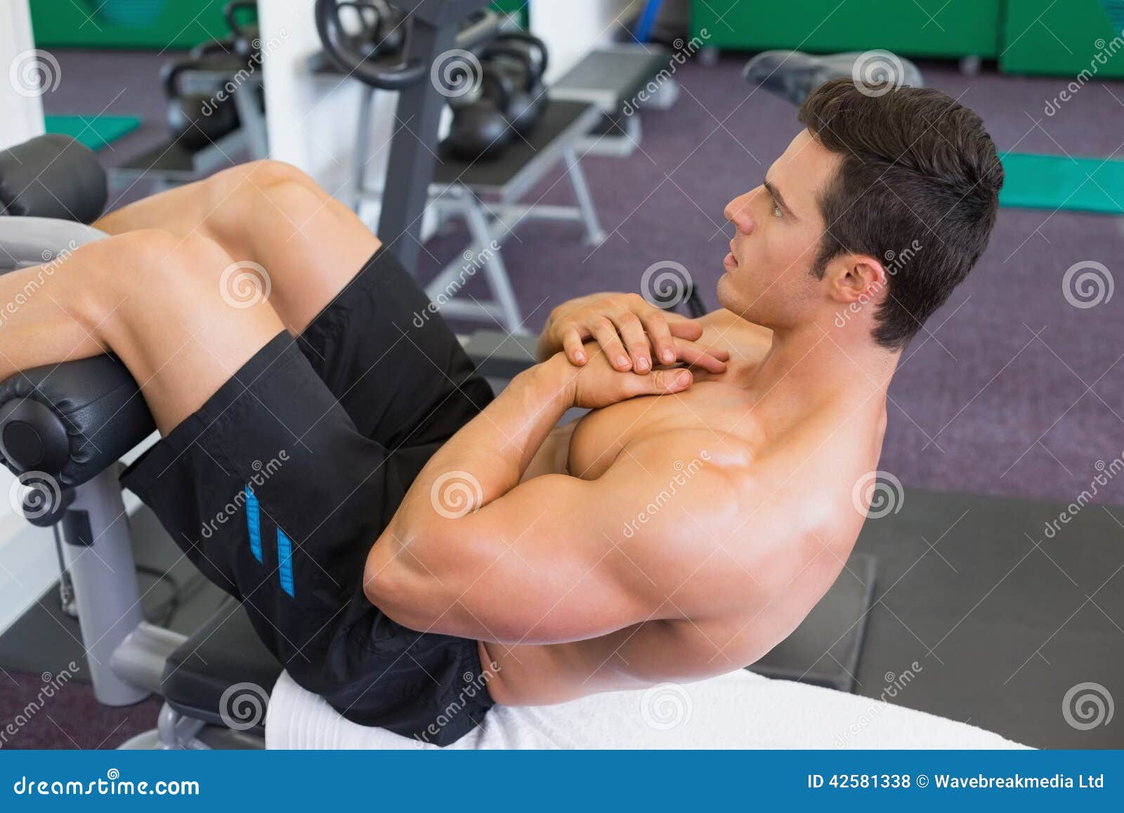 Muscular Man Doing Abdominal Crunches in Gym Stock Photo - Image of ...