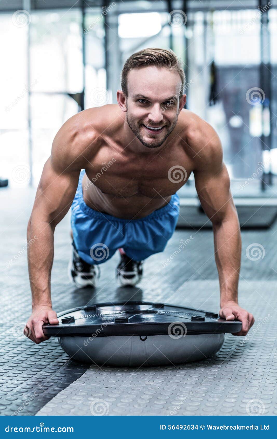 Muscular Man Doing Bosu Ball Exercises Stock Photo - Image of indoors ...
