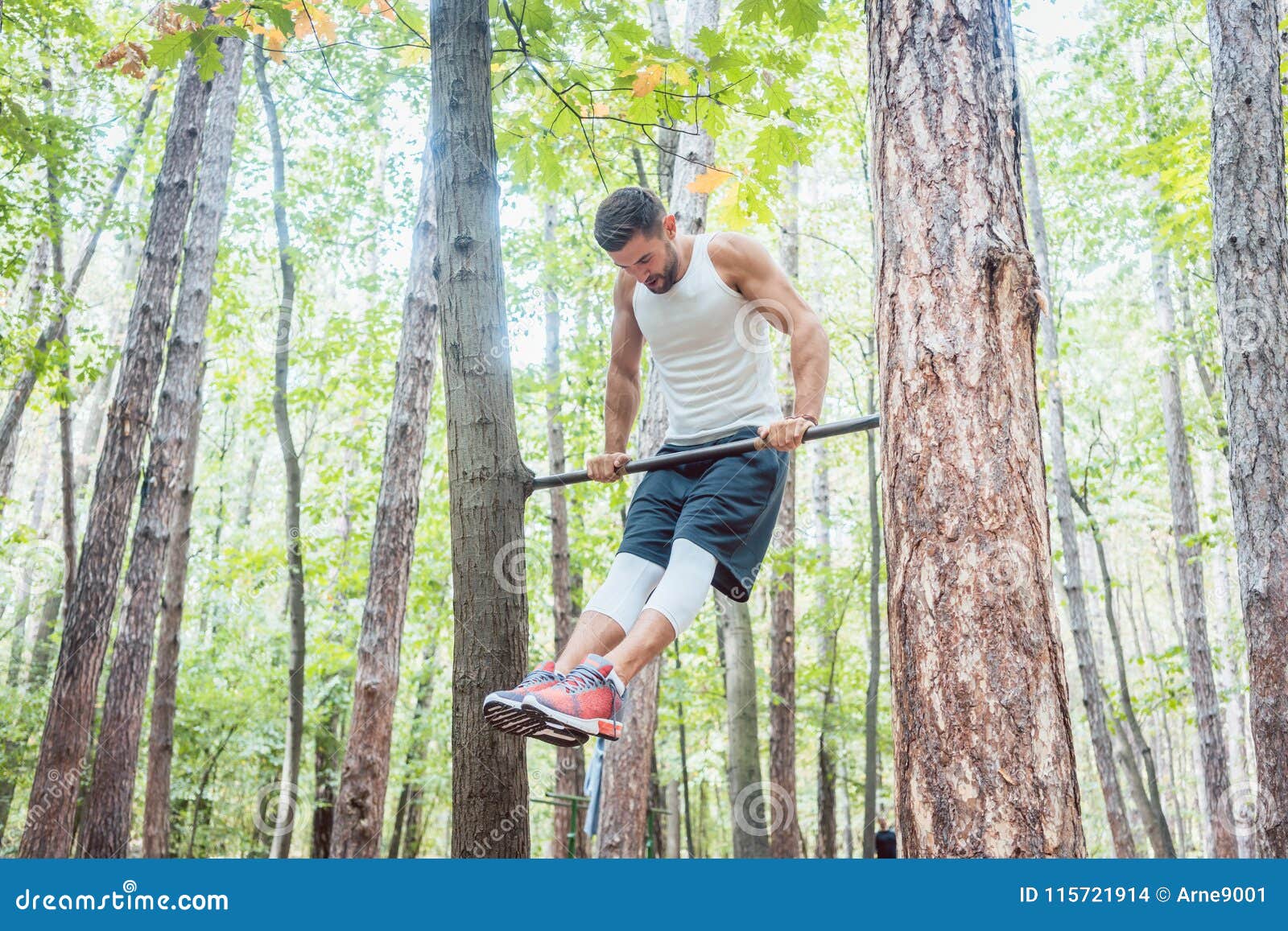 Man Doing Gymnastics on High Bar in the Woods Stock Photo - Image of ...
