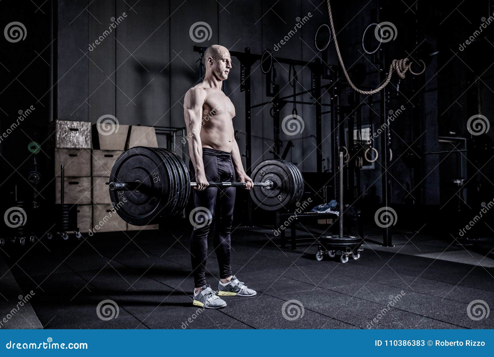 Muscular Man Doing Heavy Deadlift Exercise. Dramatic Color Grading ...