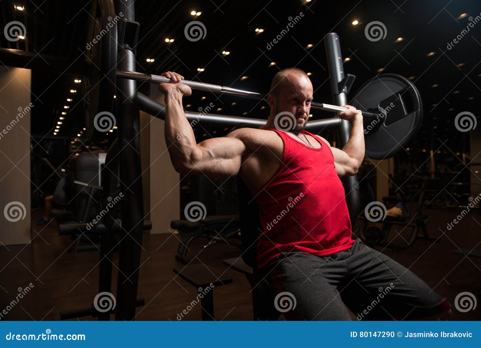 Muscular Man Doing Heavy Weight Exercise for Shoulders Stock Photo ...