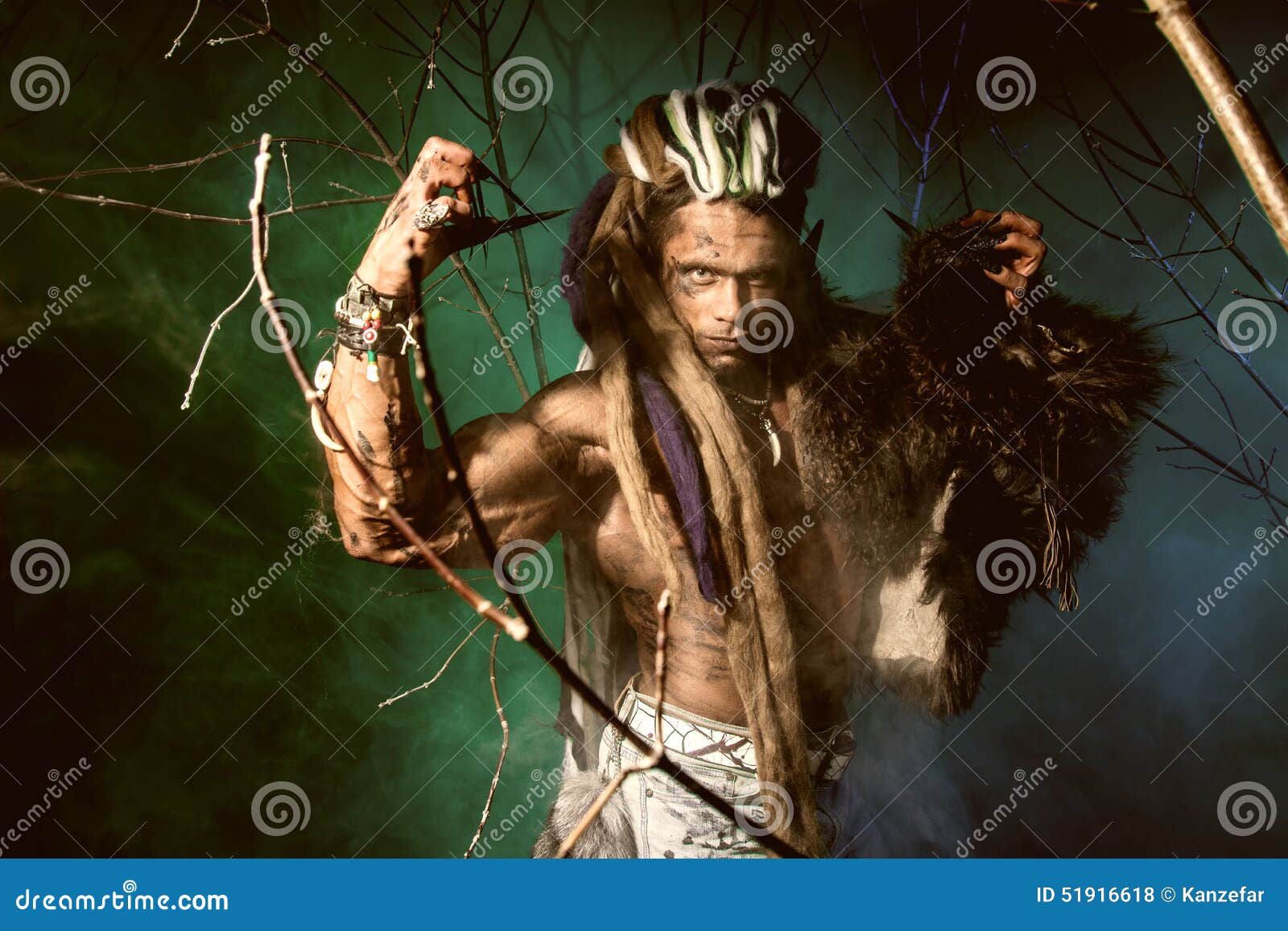 Muscular Man with Dreadlocks and Skin through the Trees and Mist Stock ...