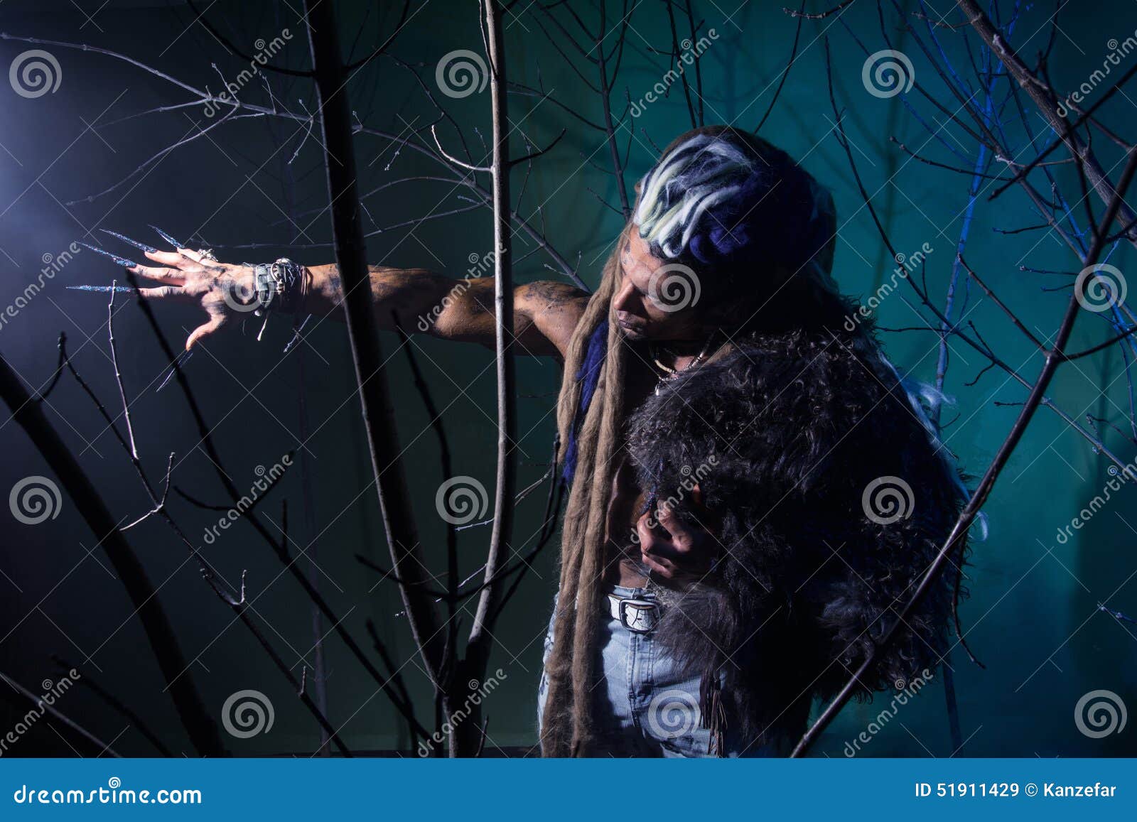 Muscular Man with Dreadlocks and Skin through the Trees. Stock Image ...