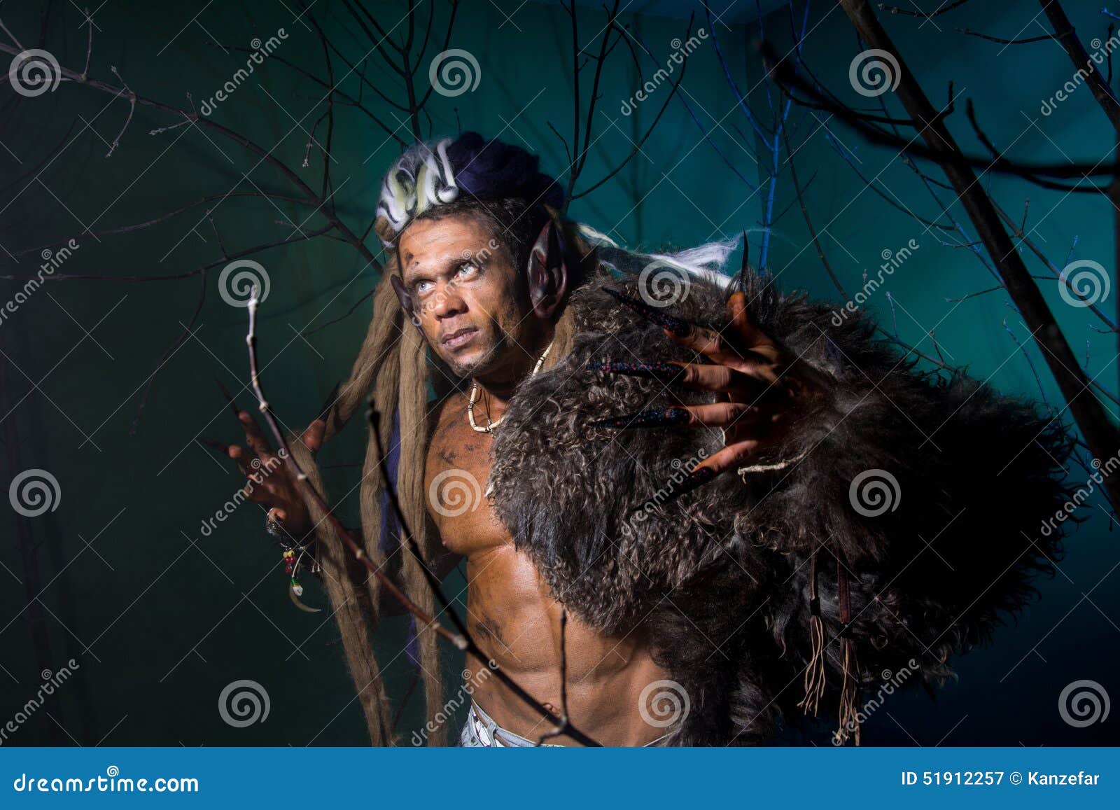 Muscular Man with Dreadlocks and Skin through the Trees. Stock Image ...
