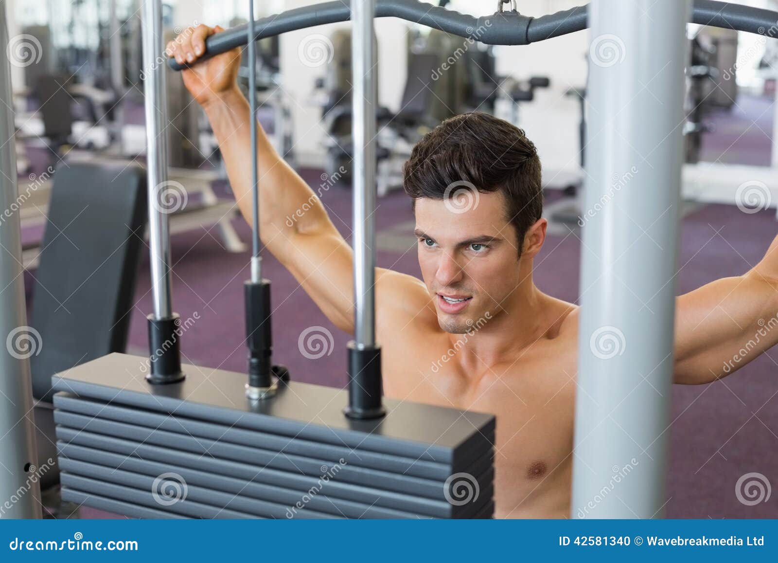 Muscular Man Exercising on a Lat Machine in Gym Stock Photo - Image of ...