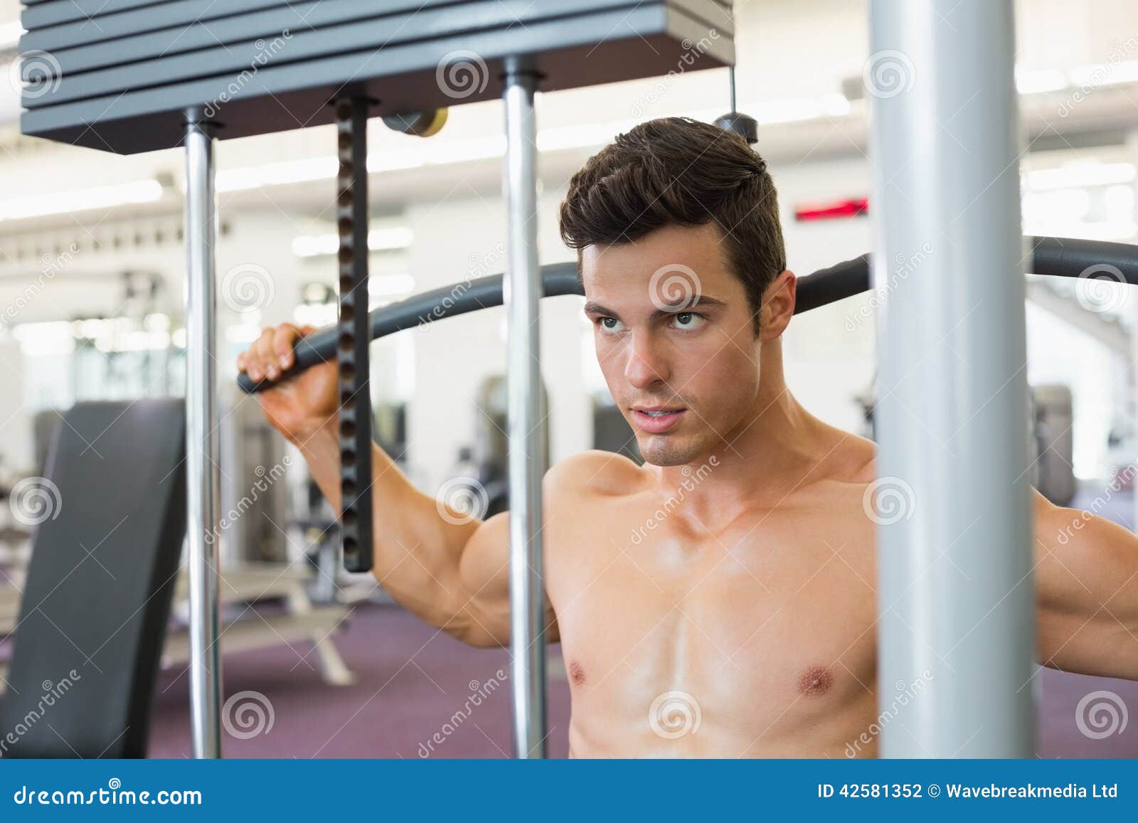 Muscular Man Exercising on a Lat Machine in Gym Stock Photo - Image of ...