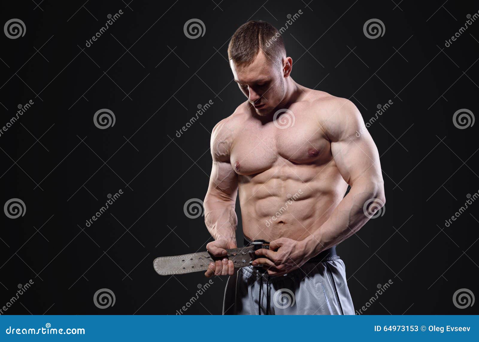Muscular Man Fasten Lifting Belt Posing Over Dark Stock Image - Image ...