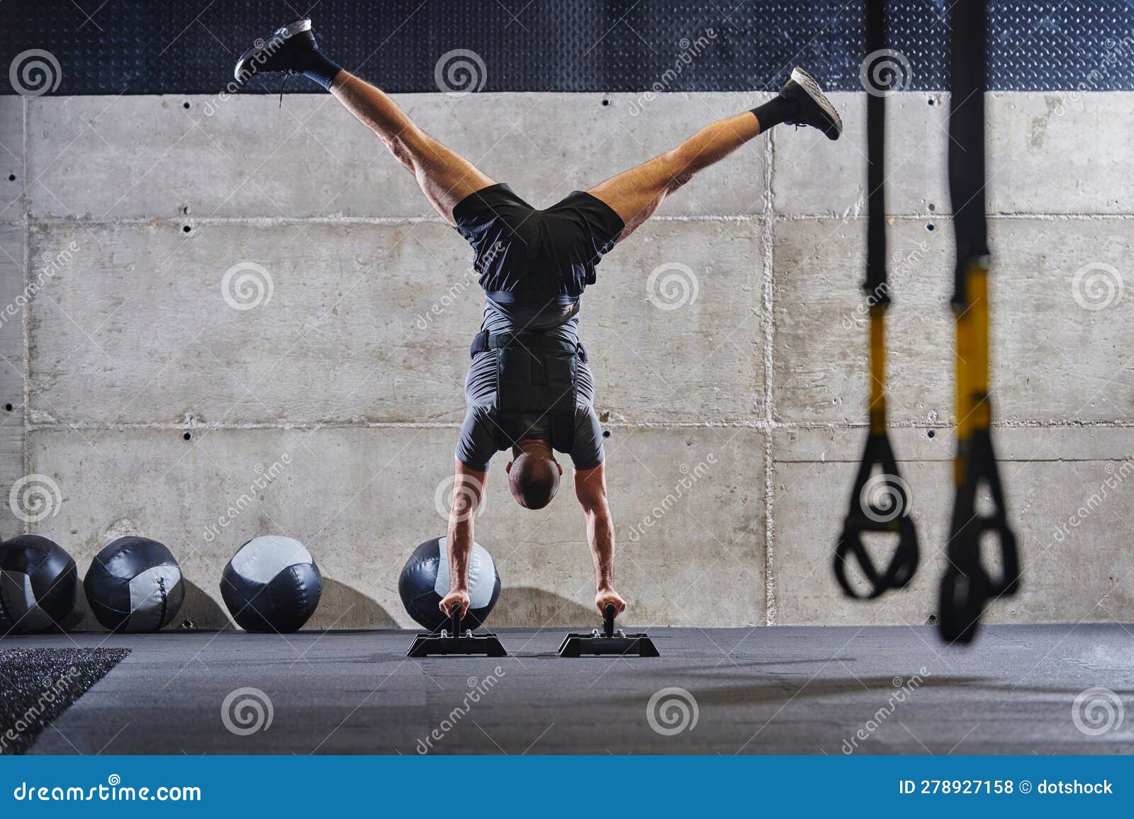 A Muscular Man In A Handstand Position Showcasing His Exceptional